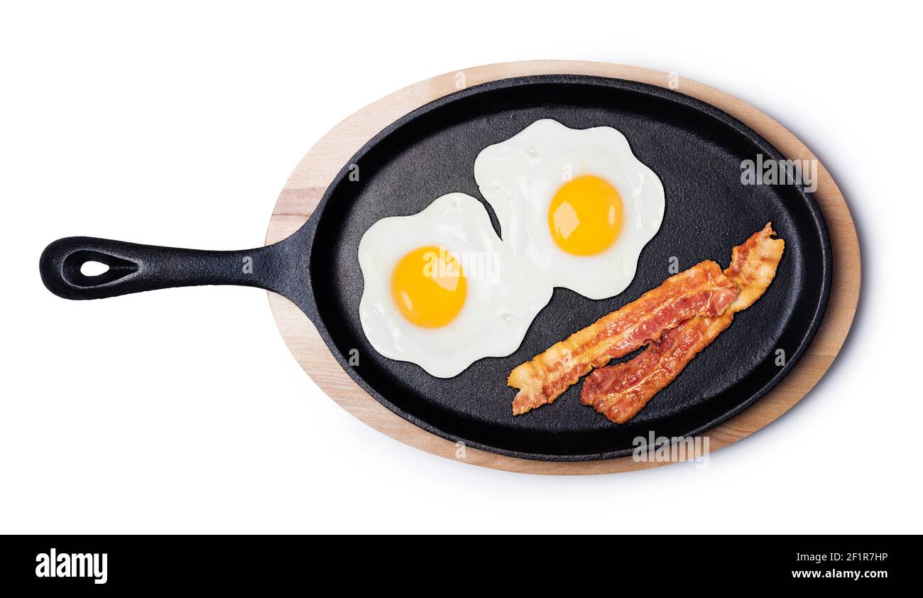 Bacon eggs cooking in Cut Out Stock Images & Pictures - Alamy
