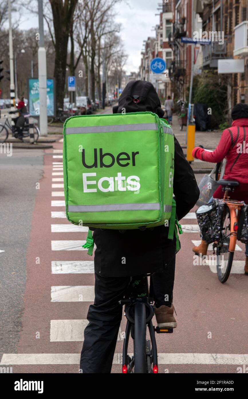 Uber Eats Delivery Rider At Amsterdam The Netherlands 9-3-2021 Stock ...