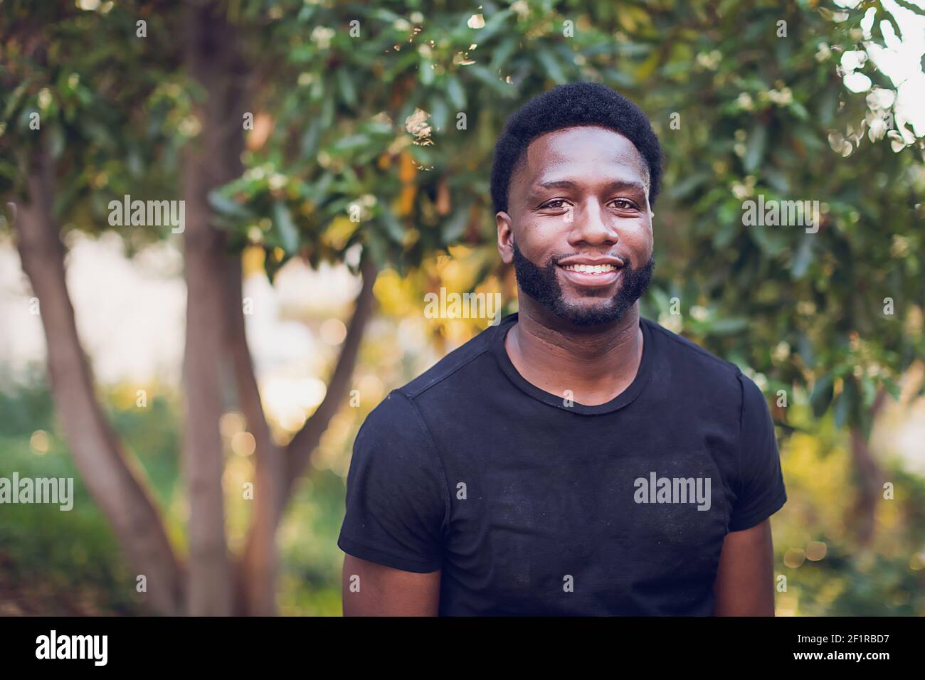 Headshot of a young man wearing a black shirt Stock Photo - Alamy
