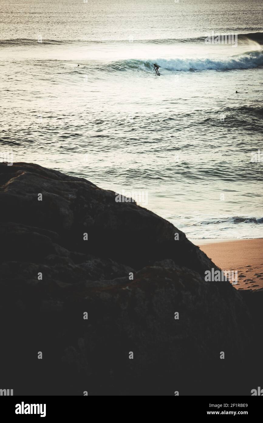 Man surfboard sunset rock hi-res stock photography and images - Alamy