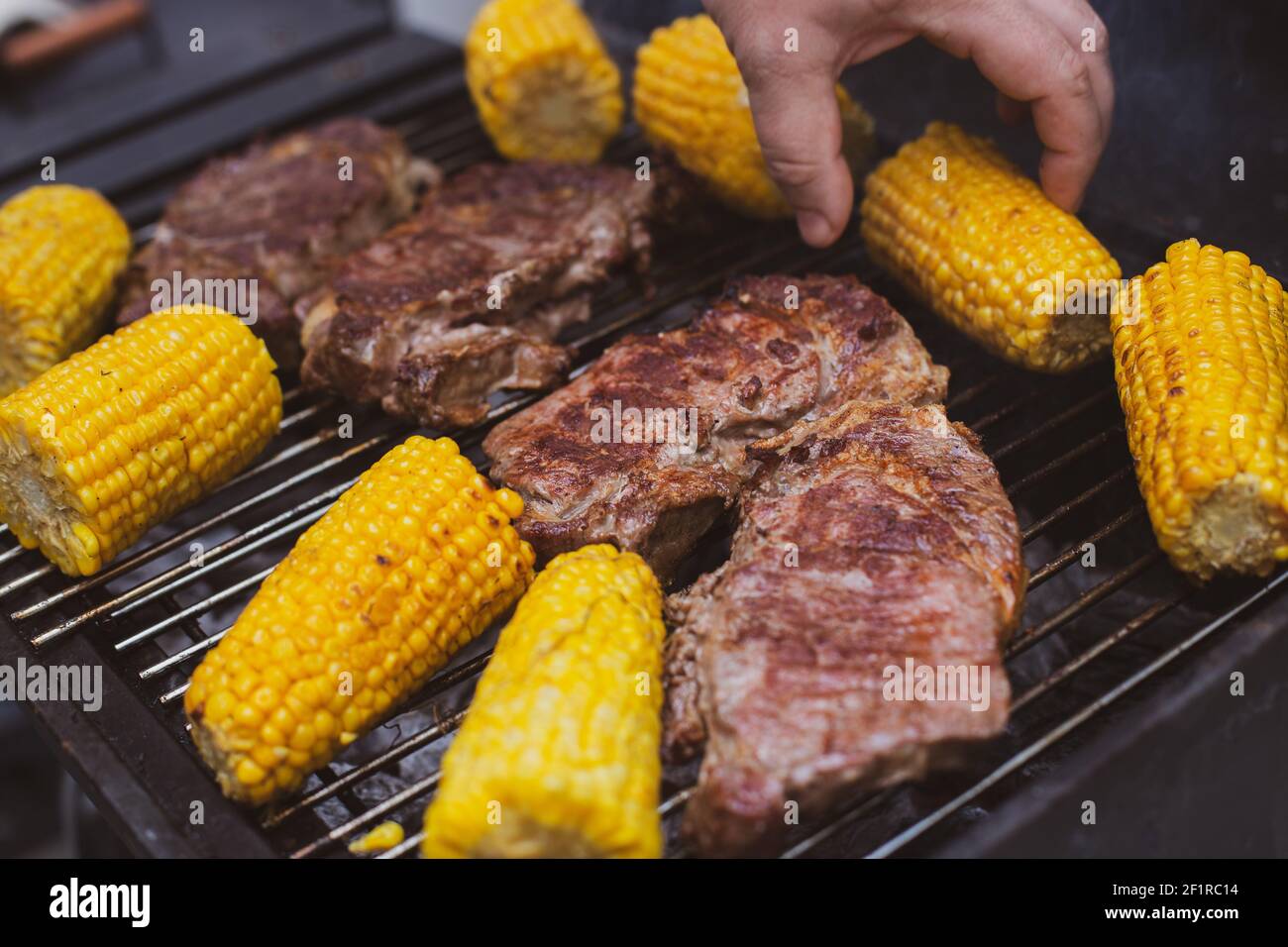 Beef steaks and corn cobs are grilled on the grill Stock Photo - Alamy