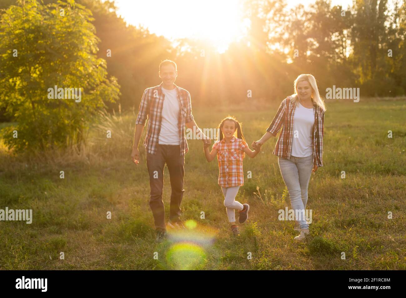 Happy family: mother father and child daughter on nature on sunset ...