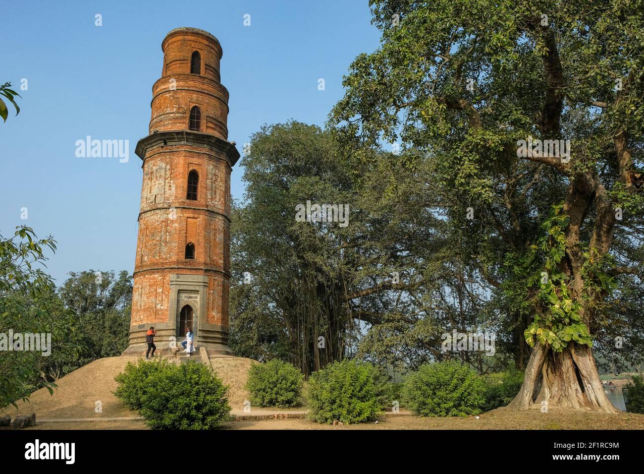 Gour, India - January 2021: A couple taking photos in the Firoz Minar ...