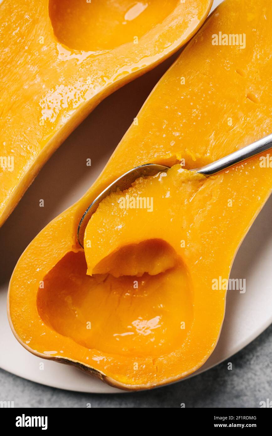 Scooping slow cooked butternut squash with a spoon Stock Photo - Alamy