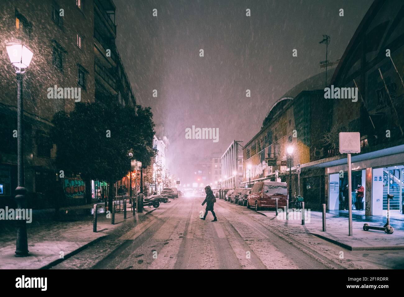 Woman crossing snowy street hi-res stock photography and images - Alamy