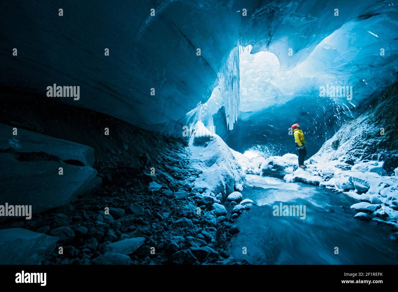 man exploring ice cave in Thórsmörk - Iceland Stock Photo - Alamy