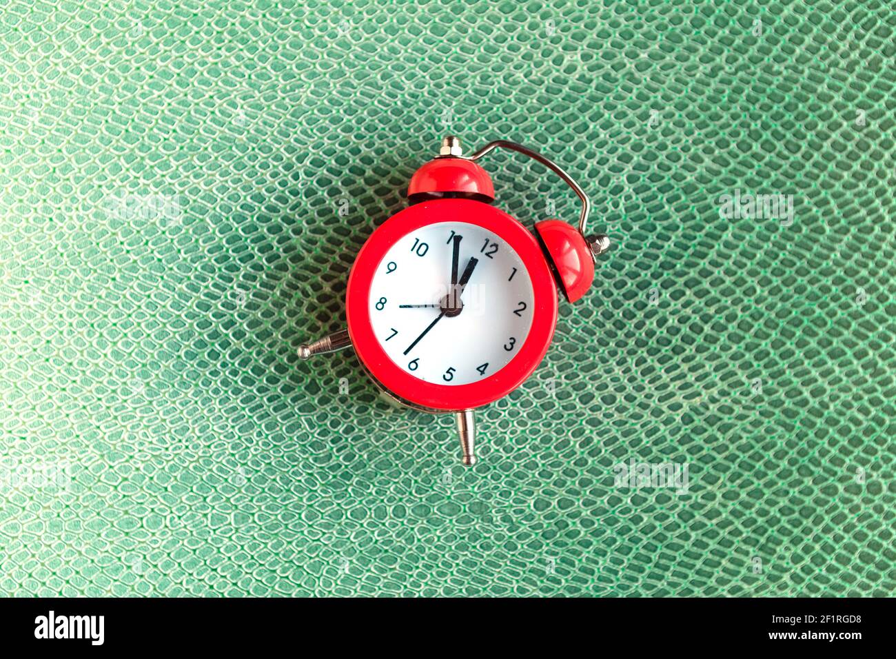 Red alarm clock on green background with pattern. Minimal concept Stock ...