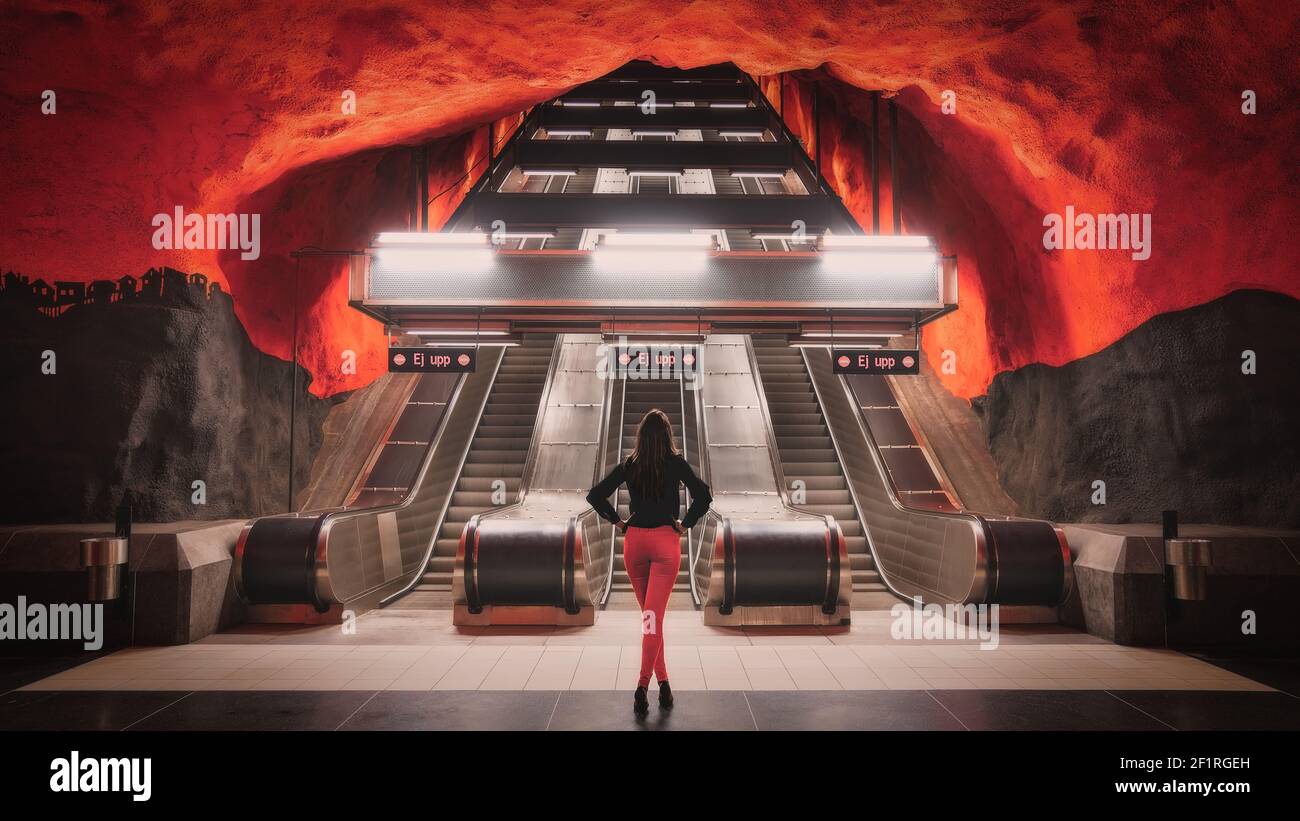 A woman stands hopelessly at a one way escalator that will only bring ...