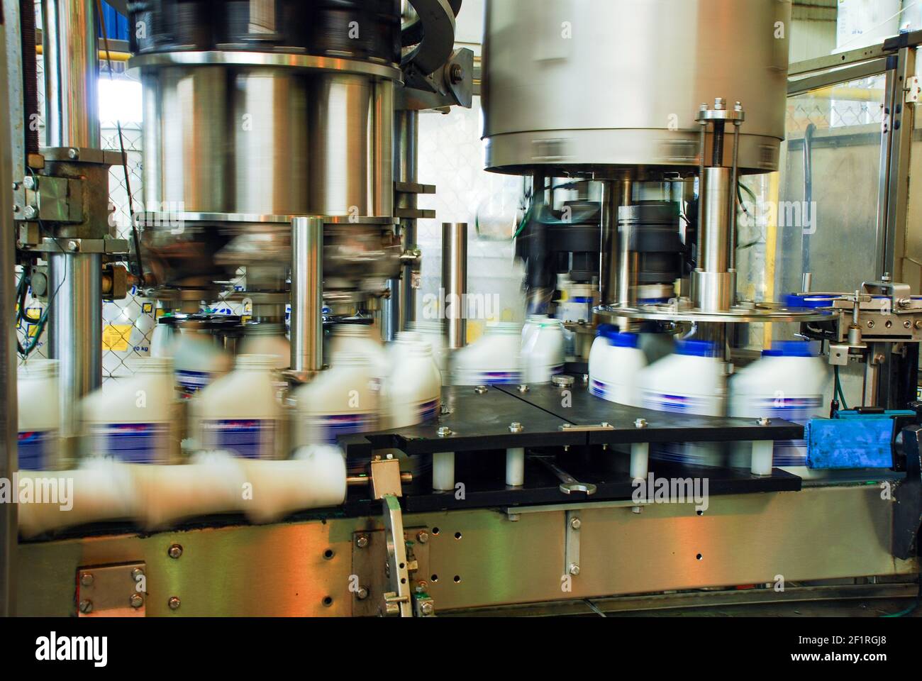 Oil is dispensed into quart bottles at a lubricant manufacturing ...