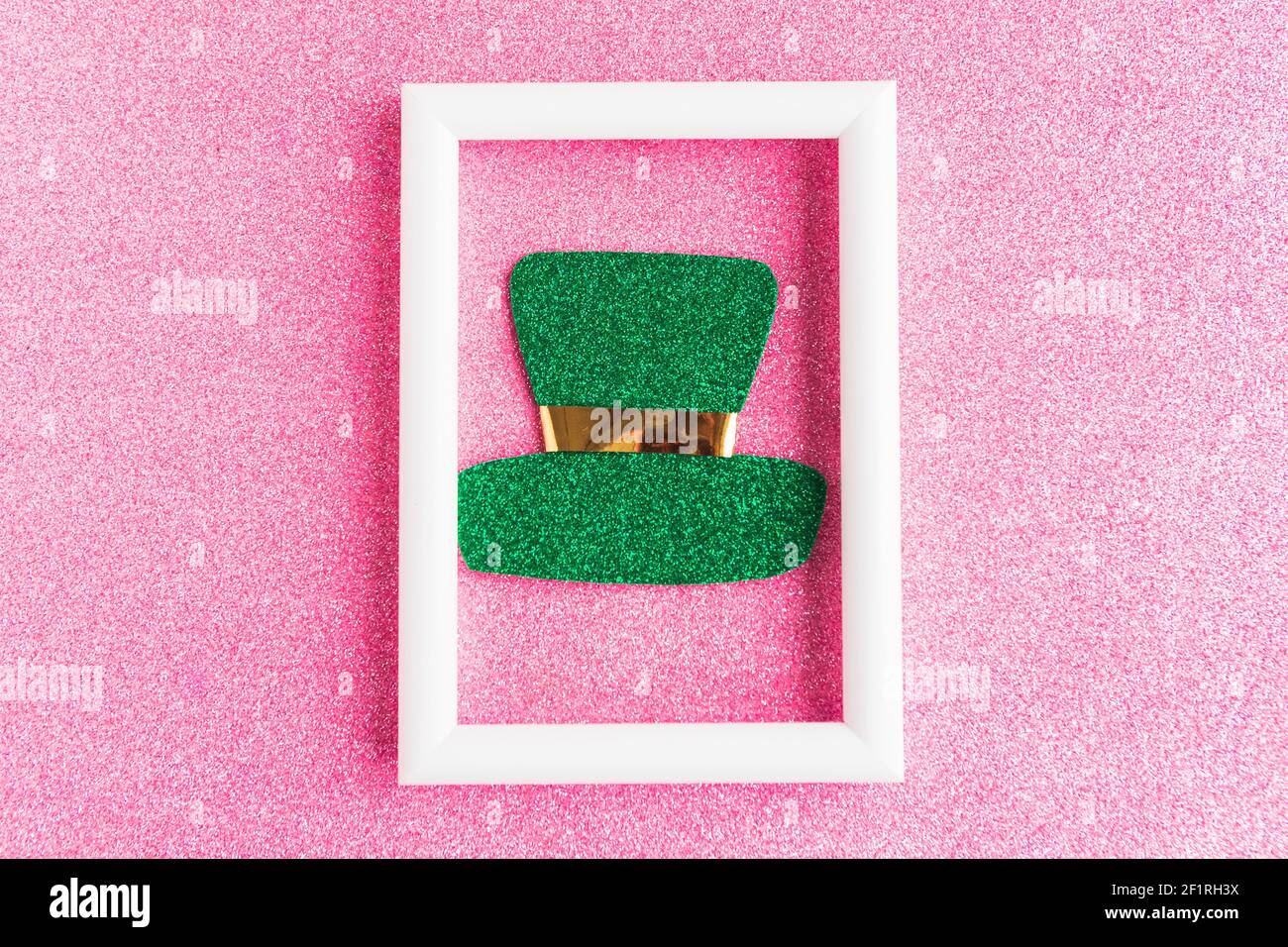 Saint Patrick leprechaun paper hat in photo frame on pink glitter ...