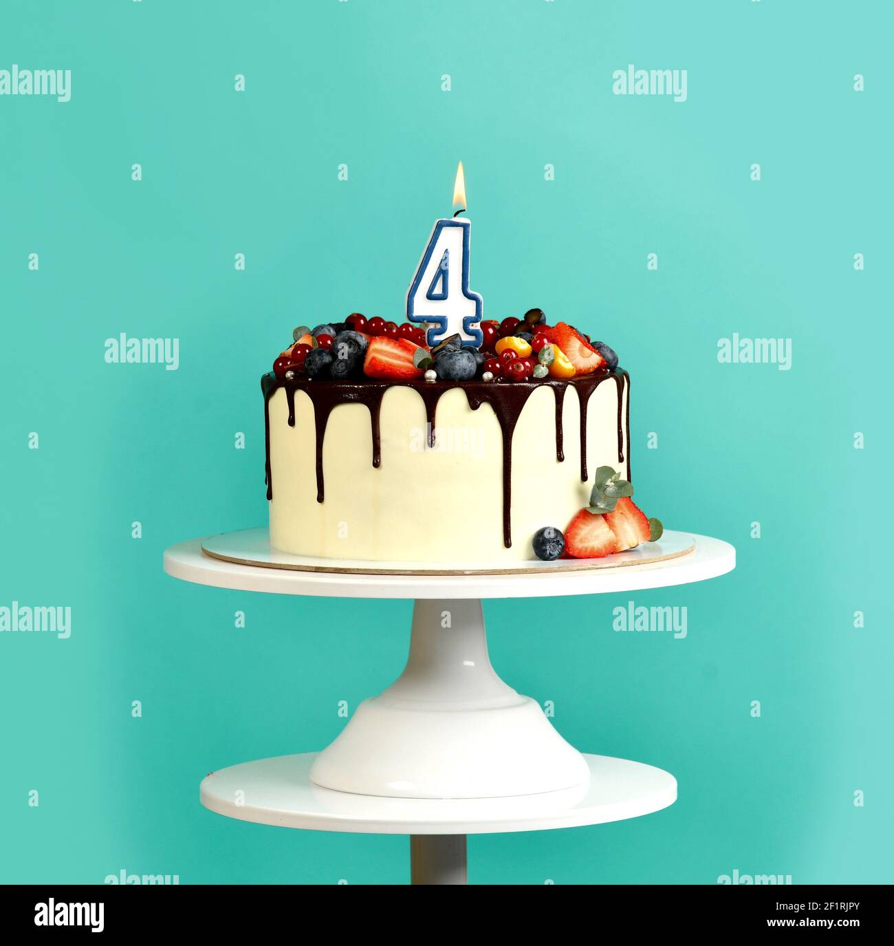 Four years old Birthday party sweet cake with chocolate drips and fresh ...