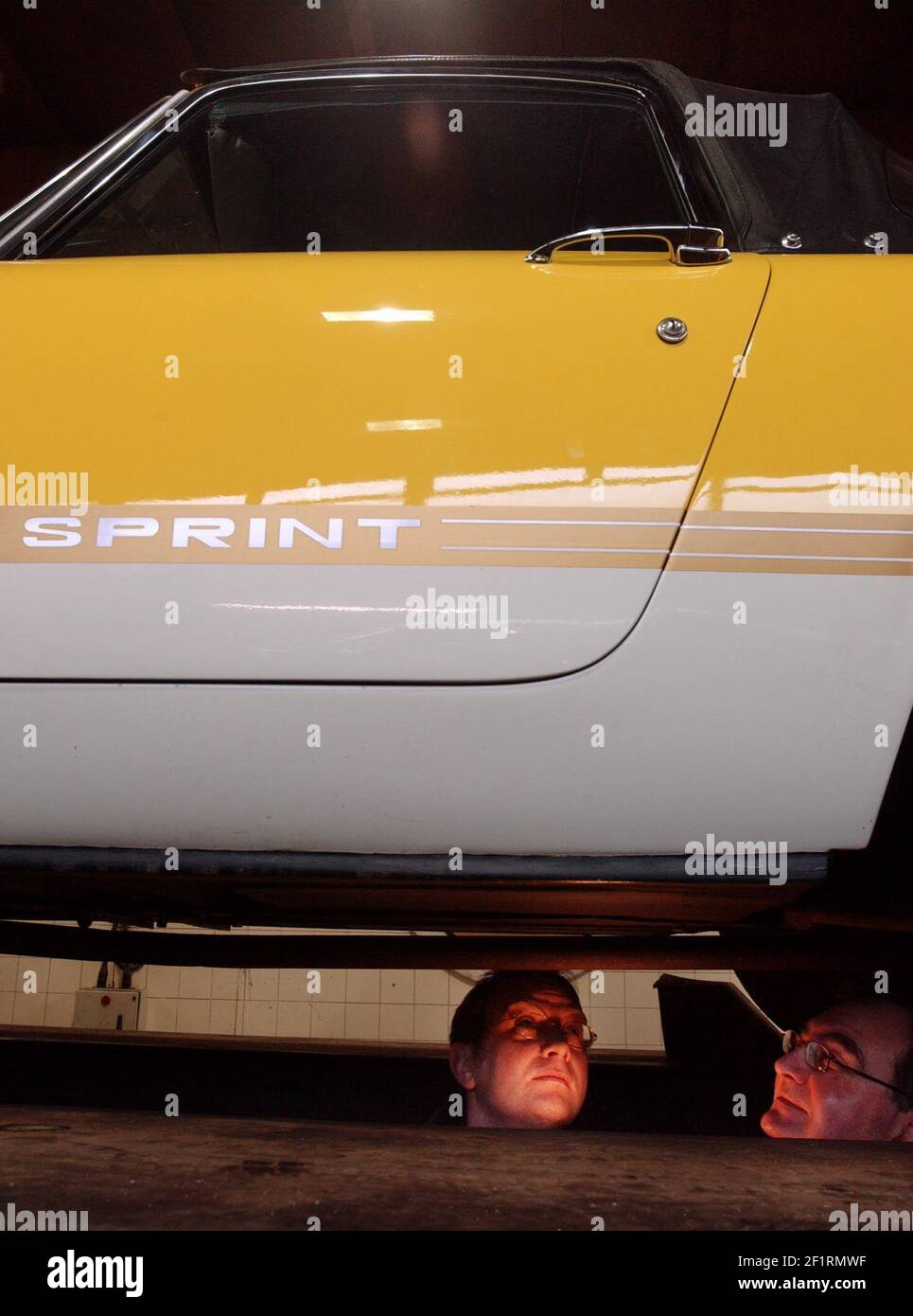PAUL MATTY SHOWS JAMES RUPPET A LOTUS ELAN SPRINT, IN HIS WORKSHOP IN ...