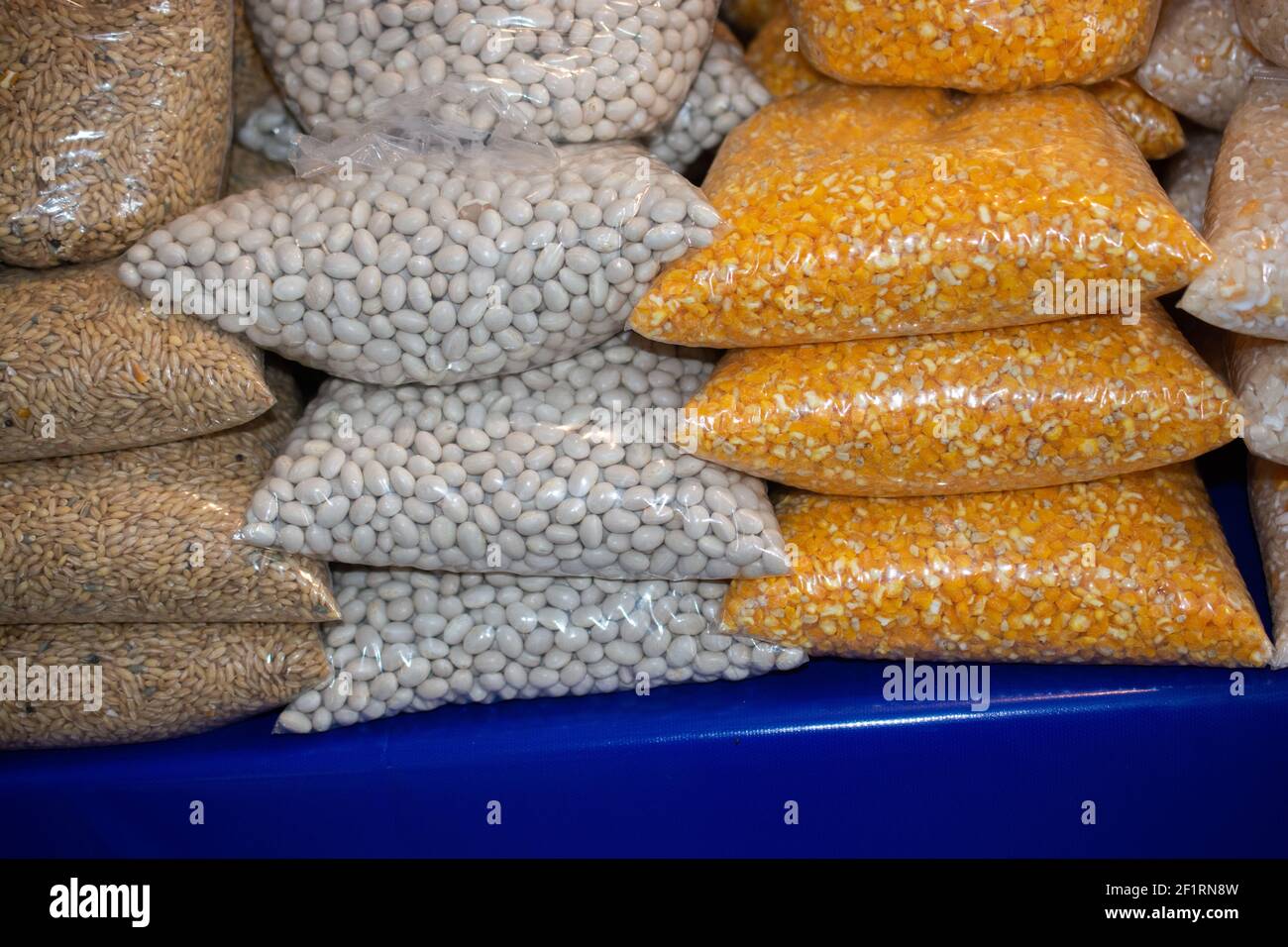 A stack of different grains on plastic packaging displayed on the ...