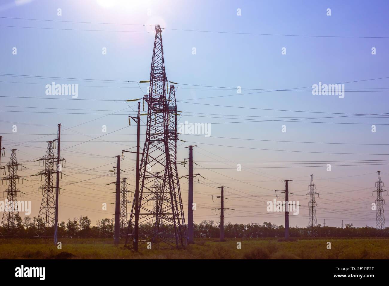 High voltage power lines, iron towers, tall iron structures against a ...