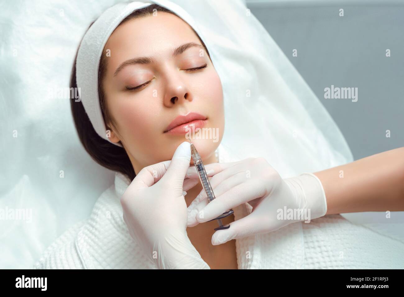 Lip augmentation and correction procedure in a cosmetology salon. The ...