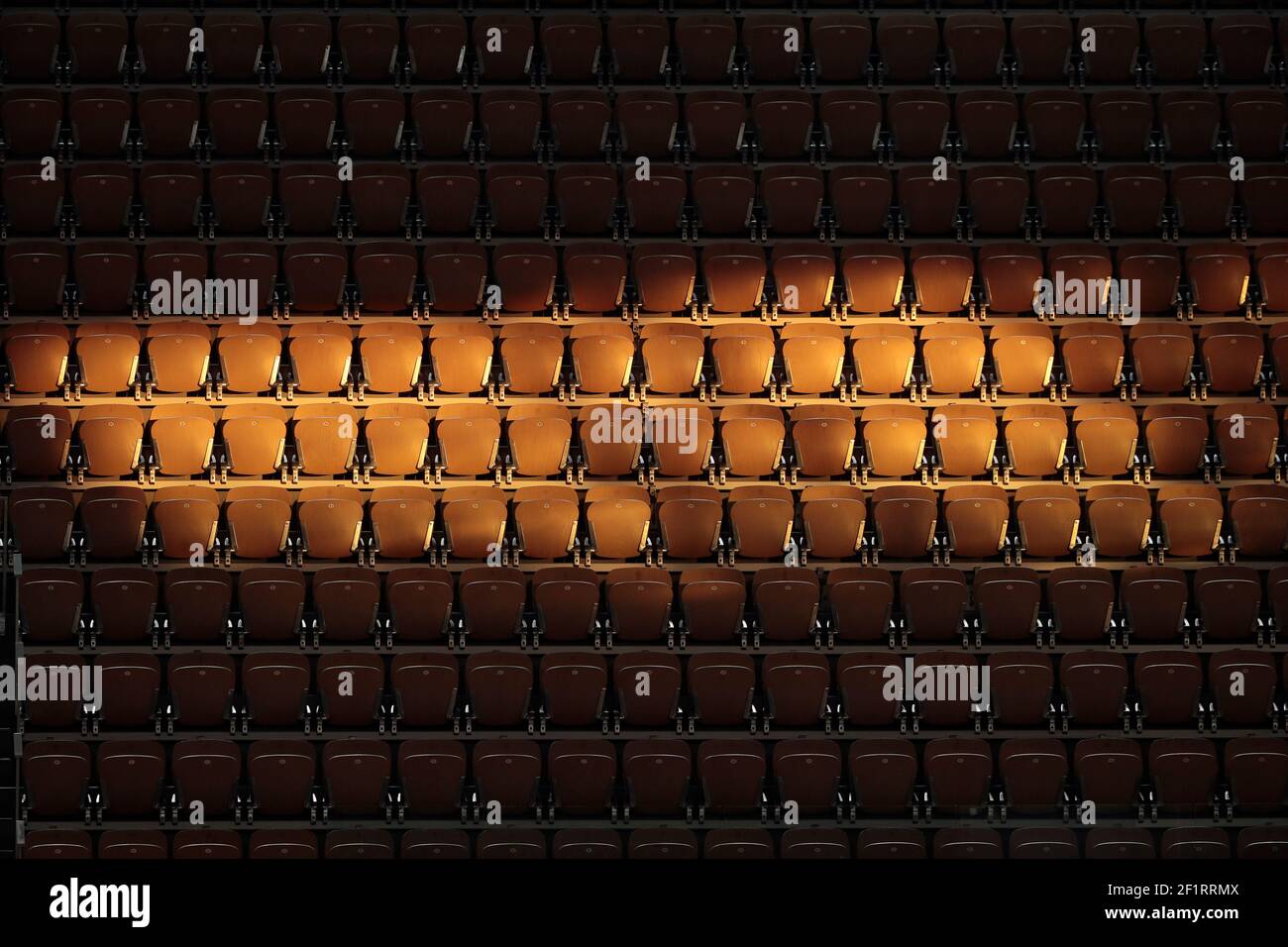 Spectator seats illuminated by a ray of sunlight penetrating through ...