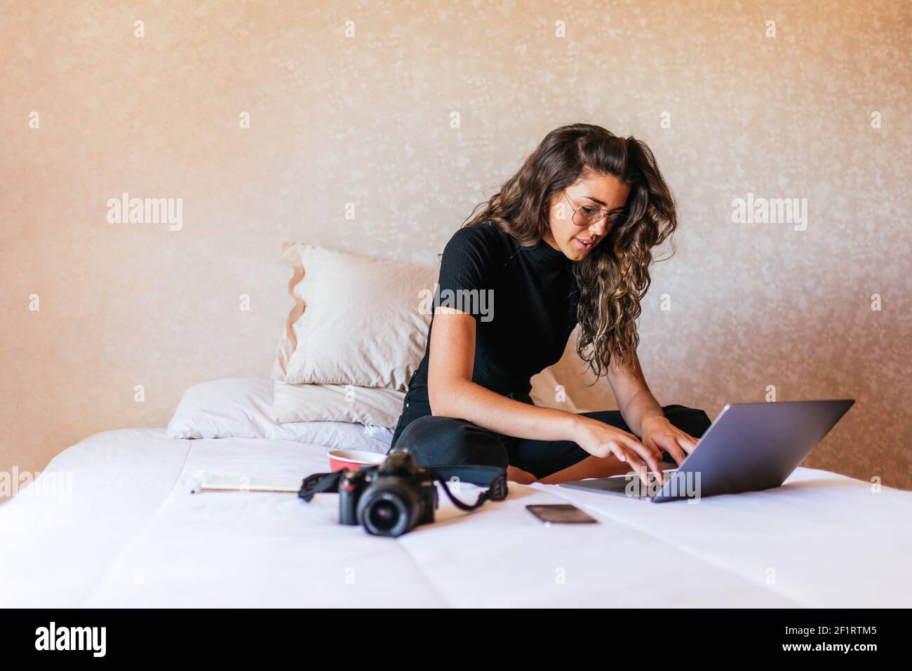 Stock photo of happy girl working with the computer in the bed and ...