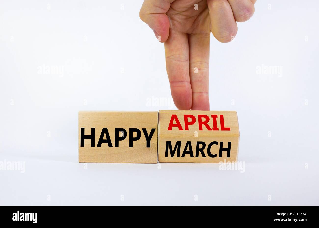 Symbol for the change from March to April. Businessman turns wooden ...