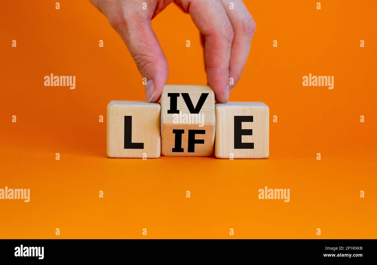 Live your life symbol. Businessman turns cubes and changes the word ...