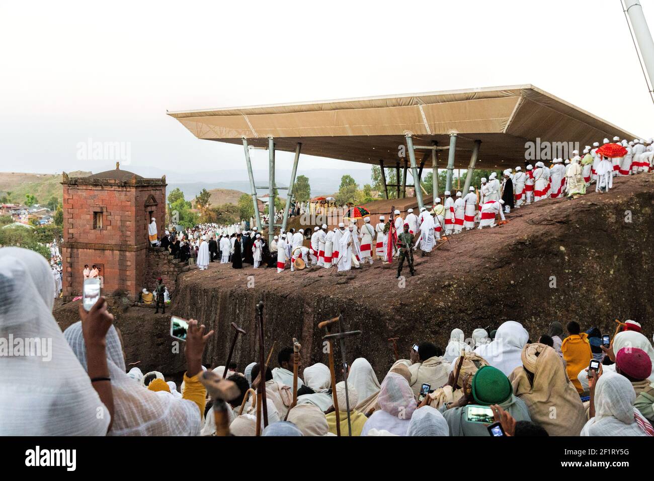 Pilgrims watch the Christmas morning procession of Priests and Deacons ...