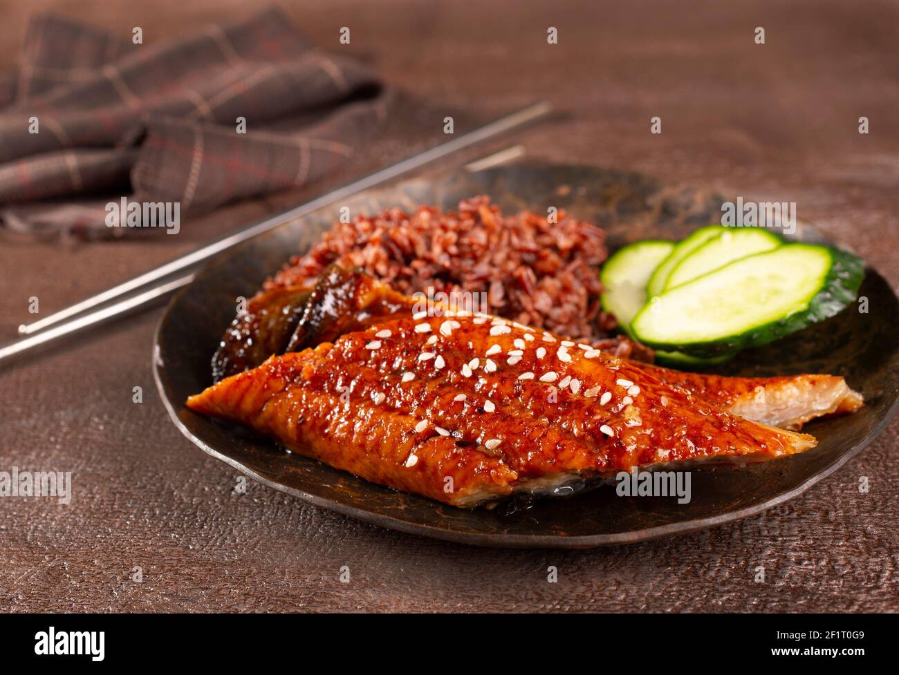 Fried unagi eel with sauce sesame and rice close-up Stock Photo - Alamy