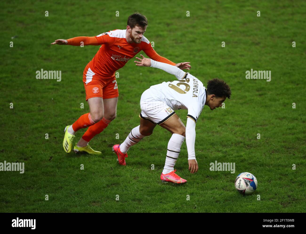 Milton Keynes Dons' Matthew Sorinola and Blackpool's Ollie Turton (left ...