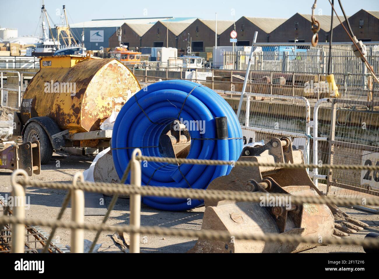 A coil of blue ducting ready to be installed underground. Blue piping ...