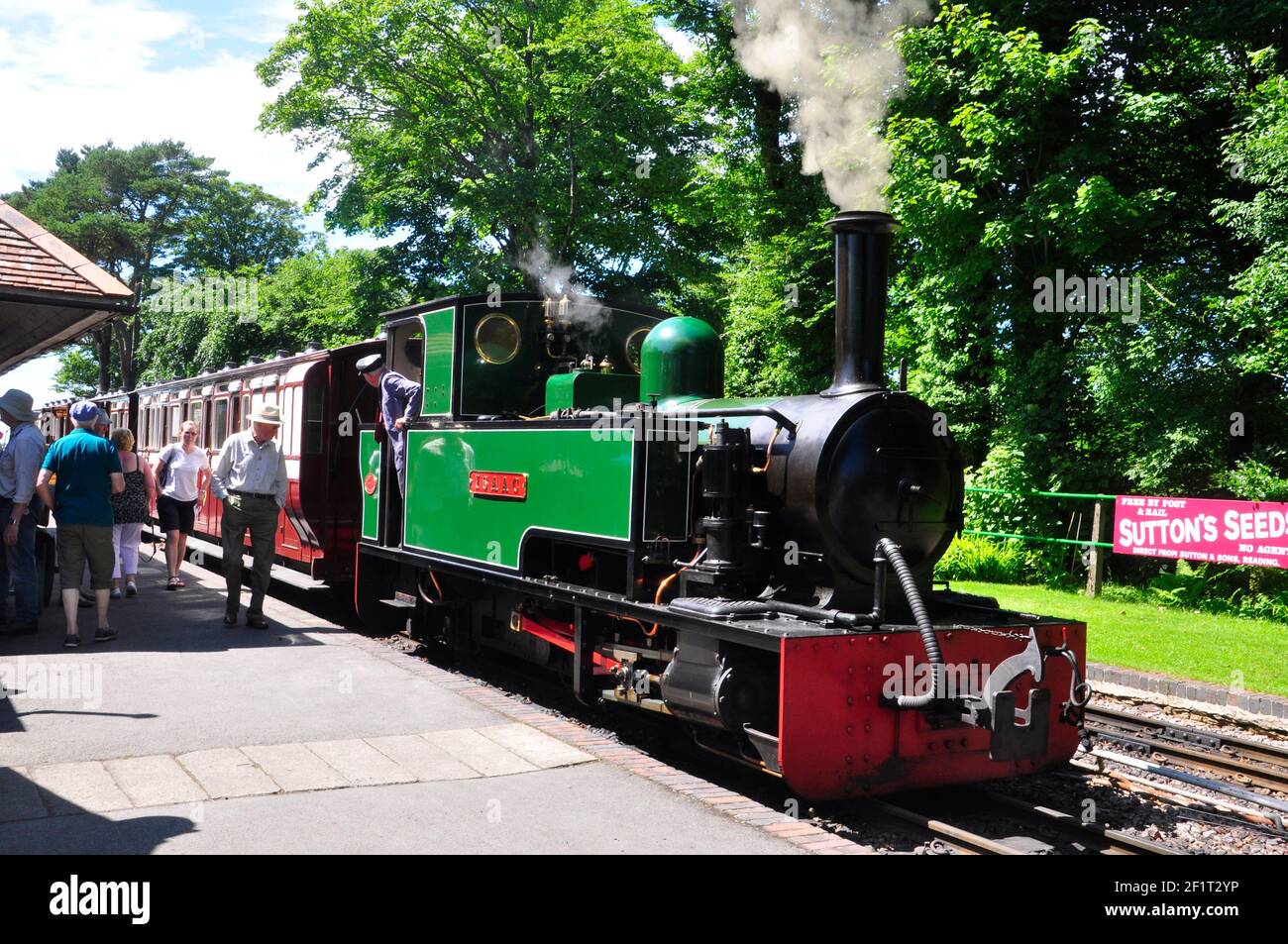 Passengers ready to board the train pulled by the steam locomotive ...