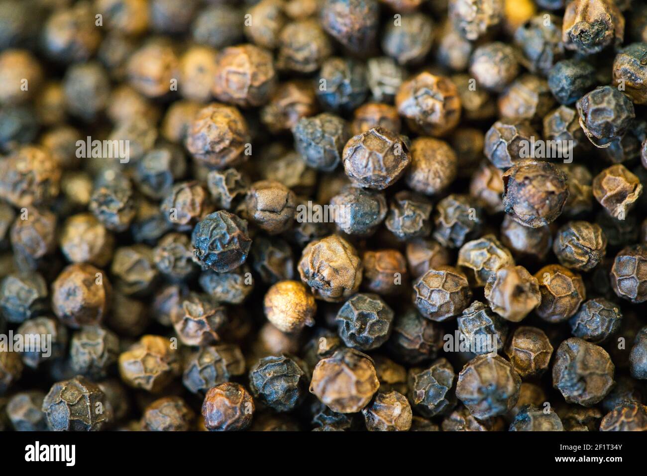 A top view closeup of multiple black pepper balls Stock Photo - Alamy