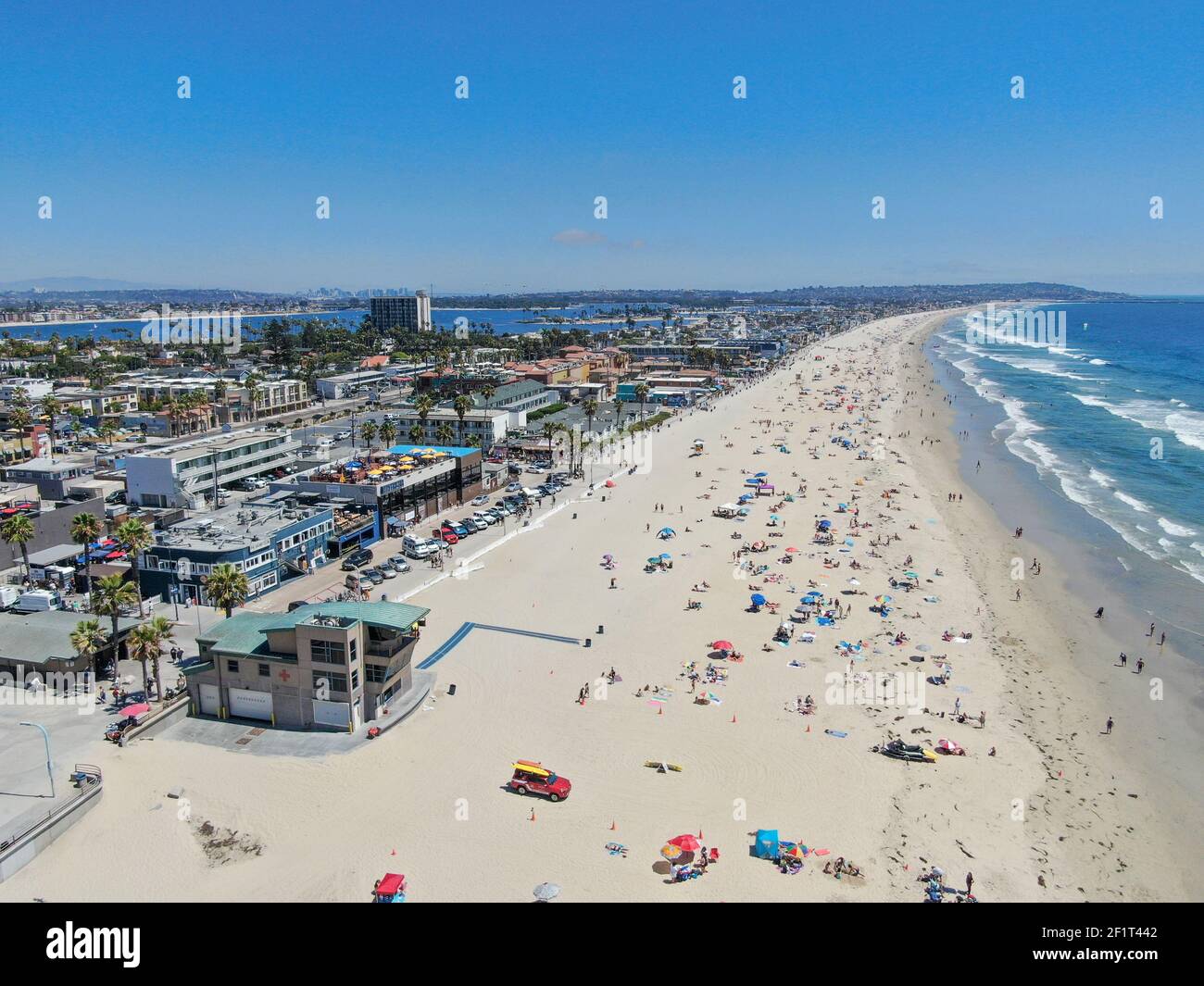 Aerial view of people at the beach enjoying the summer blue day ...