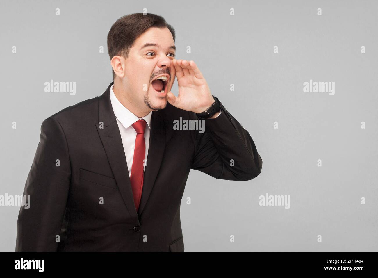 Hey some one! Worry businessman shout and fear. Indoor, studio shot ...