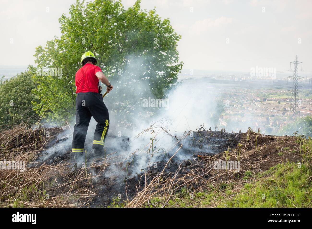 Firefighter extinguishing wildfire on Eston Hills near Middlesbrough ...