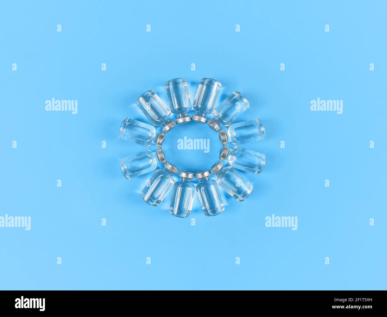 Lots of vials with liquid medicine on a blue backdrop Stock Photo - Alamy