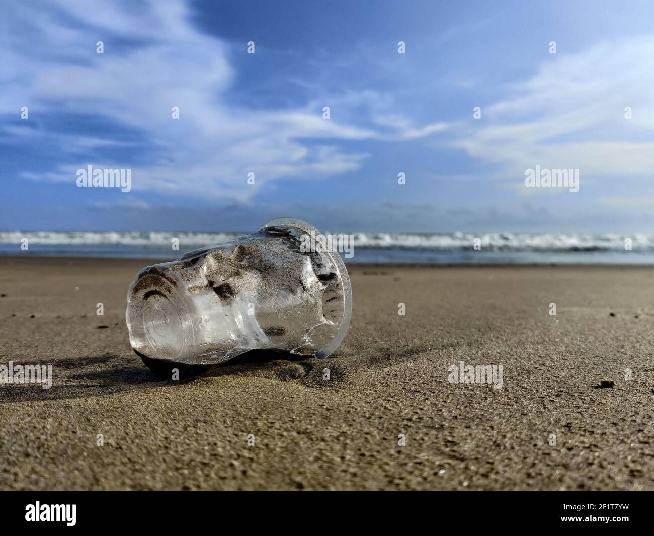 A plastic cup fallen on the beach Stock Photo - Alamy