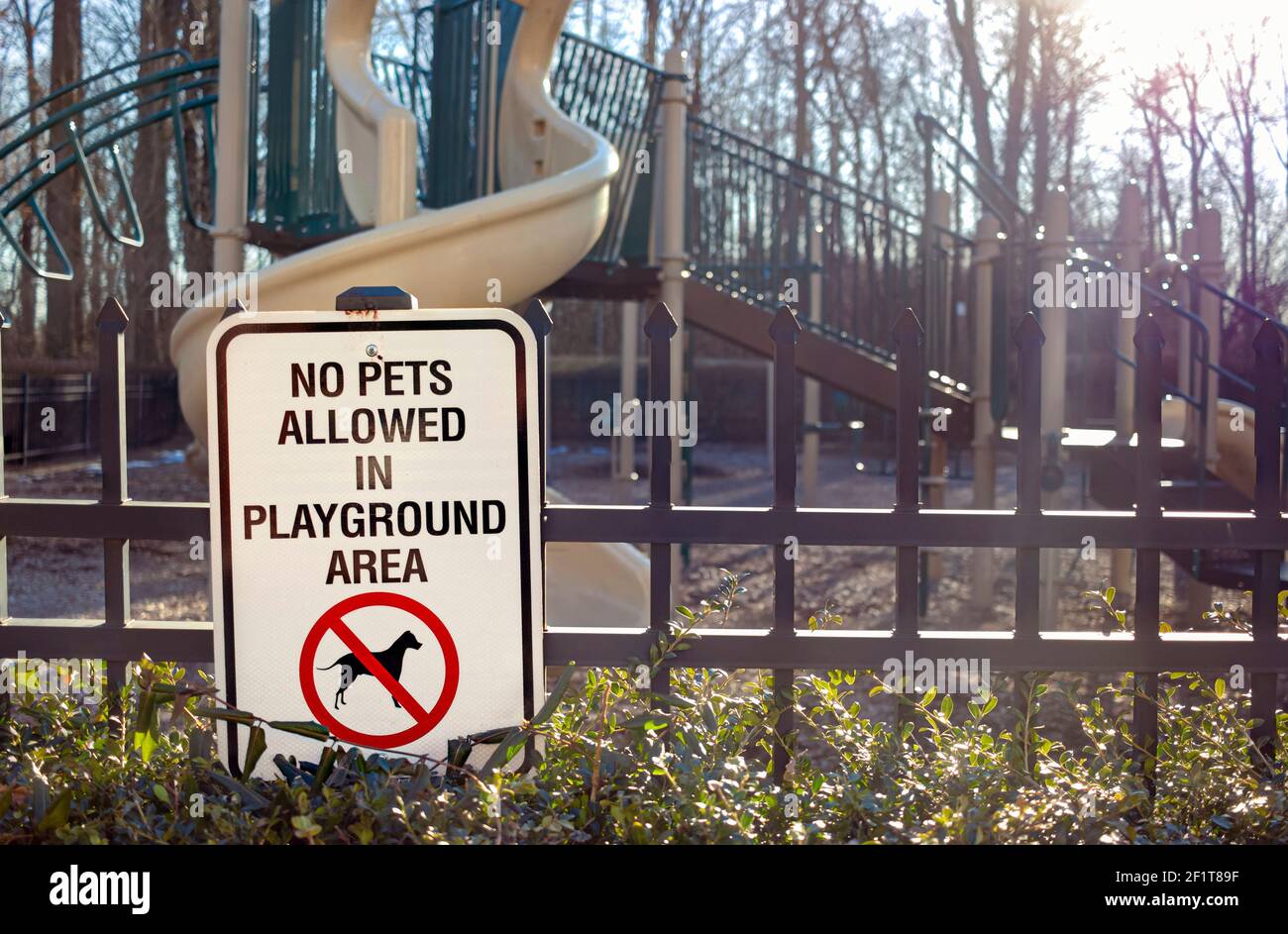 No Pets Allowed in Playground Area Sign in front of the fences at a ...