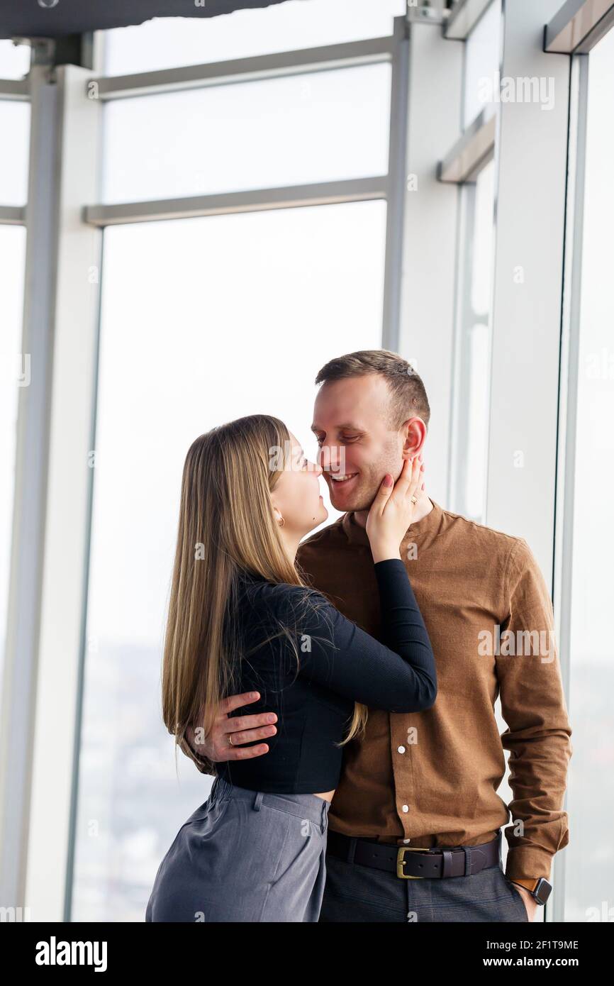 Stylish young couple in love in front of large panoramic windows. Young ...