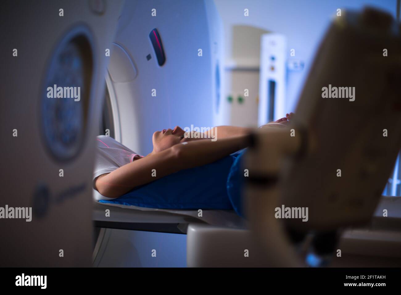 Pretty, young woman goiing through a Computerized Axial Tomography (CAT ...