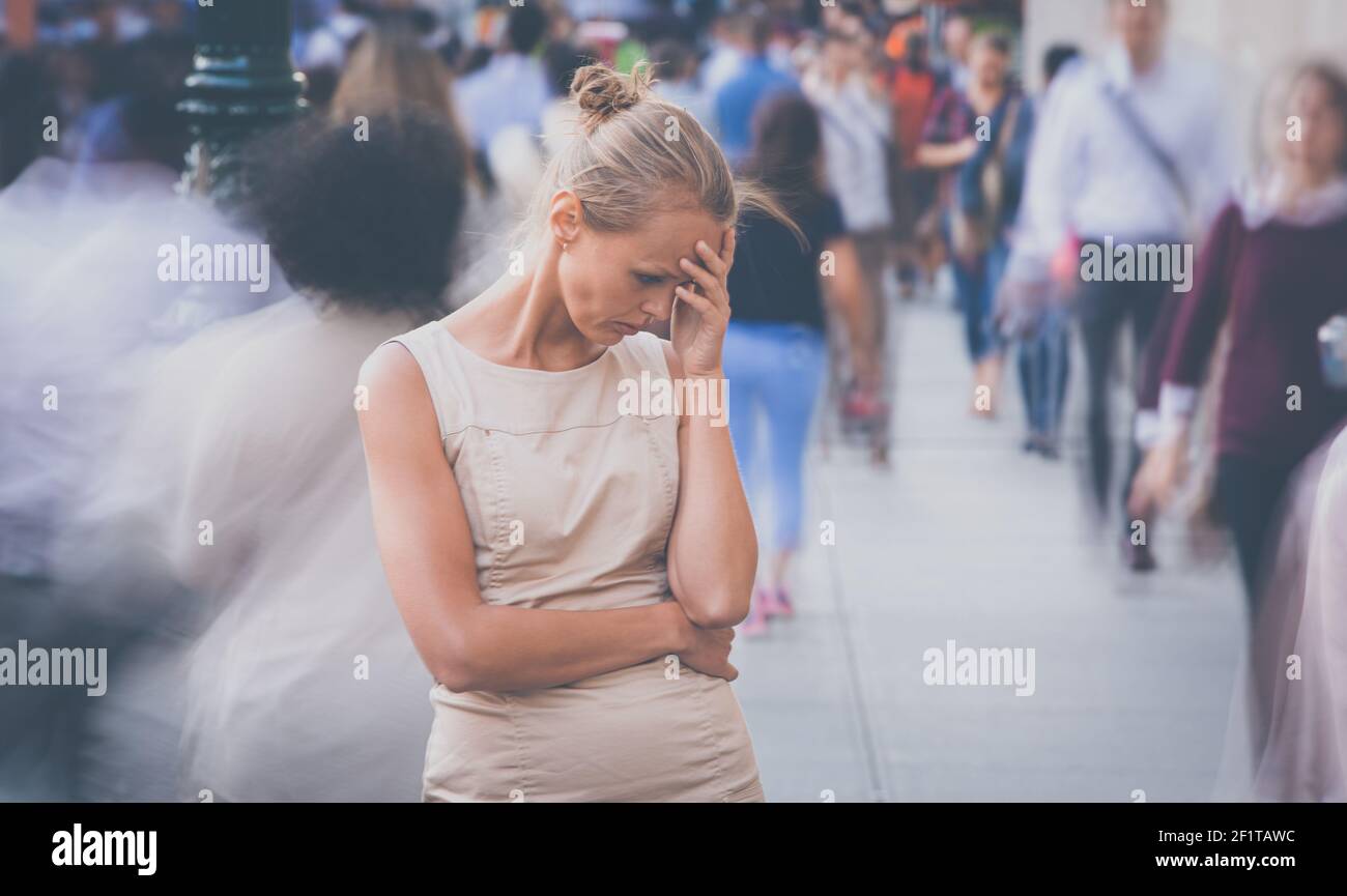 Crowd of people walking on city street - motion blurred image with ...