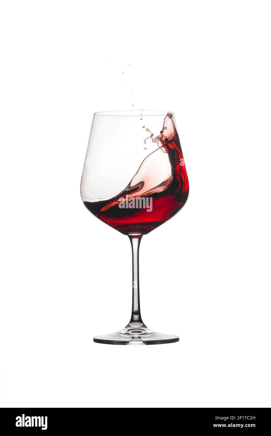 Red wine splashing out of a glass, isolated on white background. Wine ...