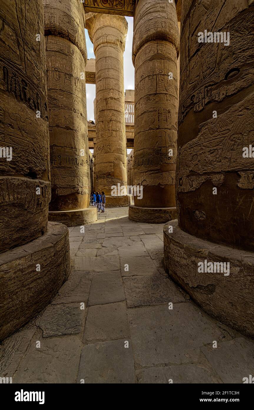Massive sandstone and mud brick columns in the hypostyle hall of the ...