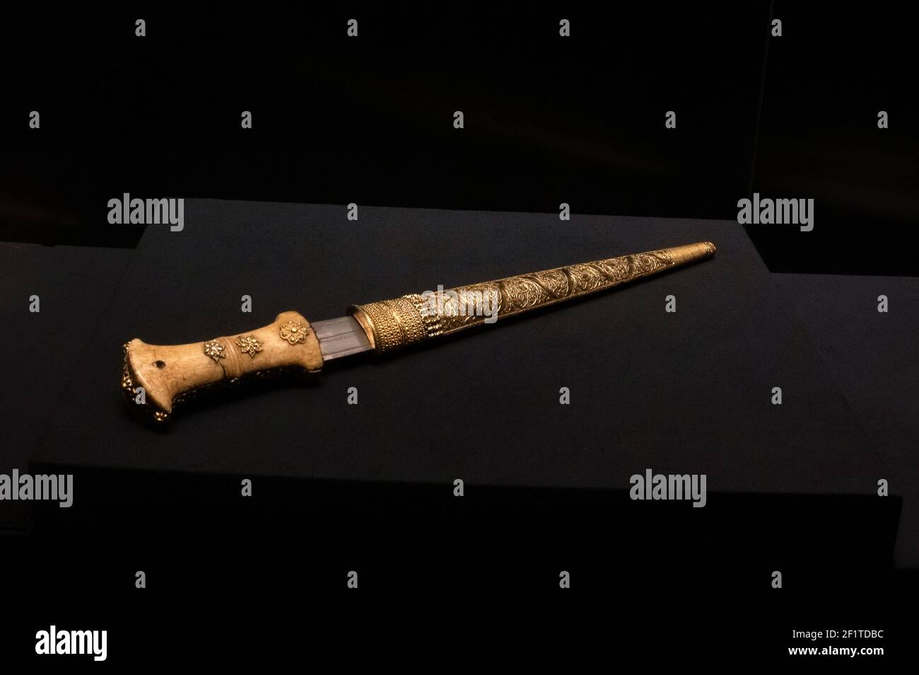 Ancient dagger on a black background of precious metals with elaborate ...