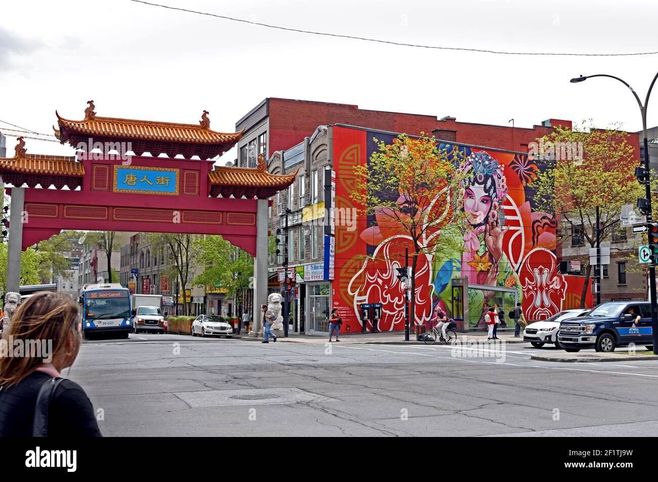 The Chinese arch gate, mural, people and traffic at the entrance of ...