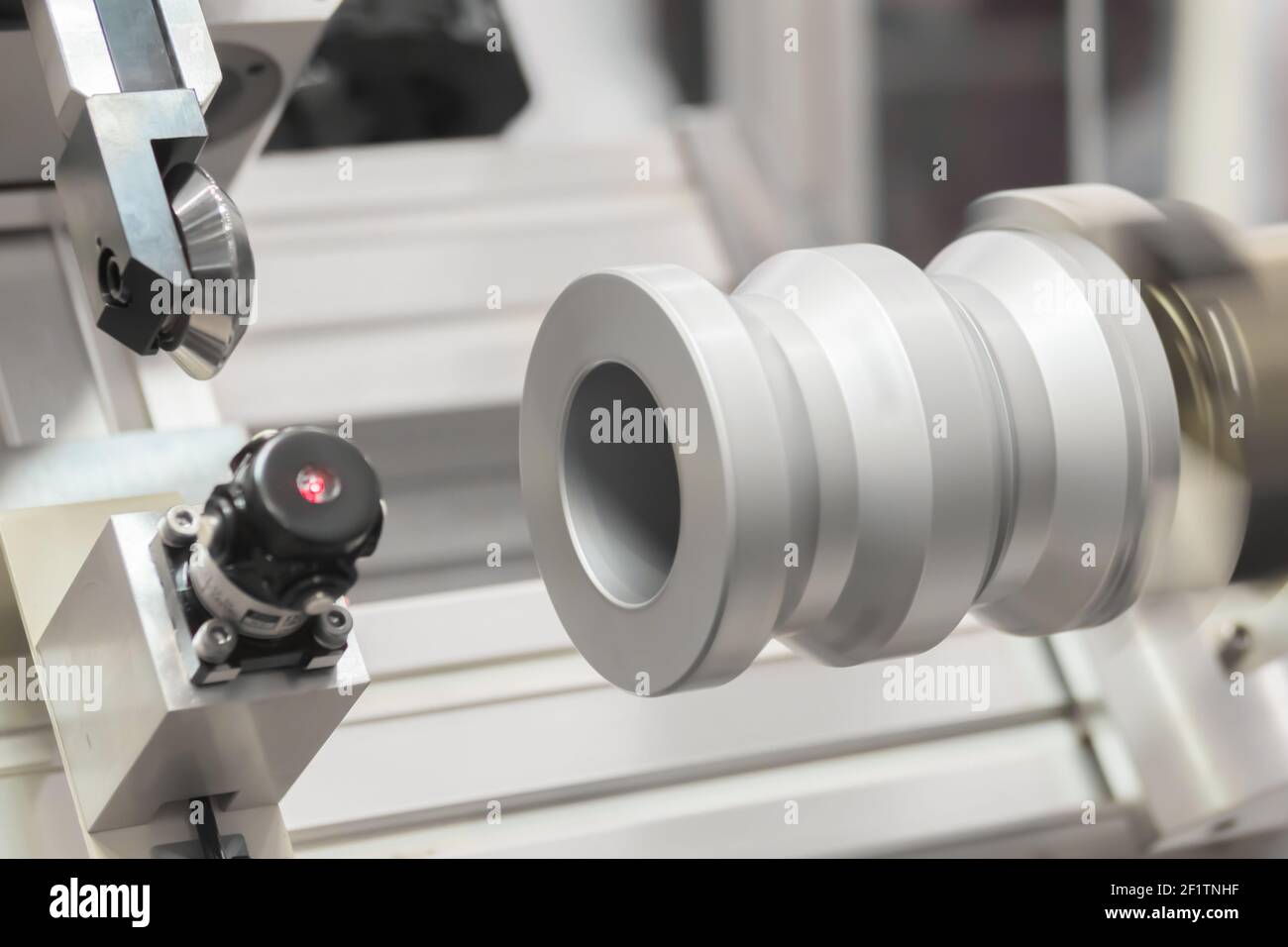 Turning milling machine cutting metal workpiece at factory - close up ...