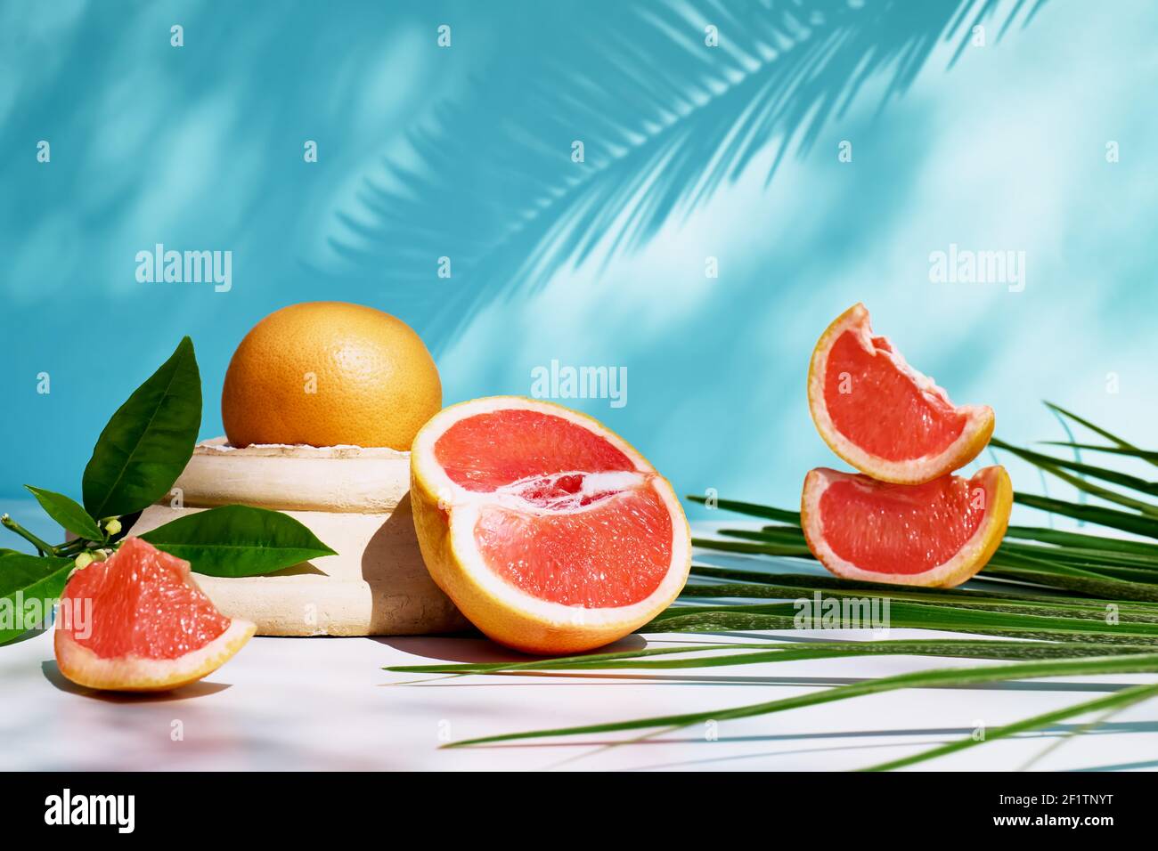 Fresh healthy grapefruit on sunlight with hard shadows. Minimal food ...