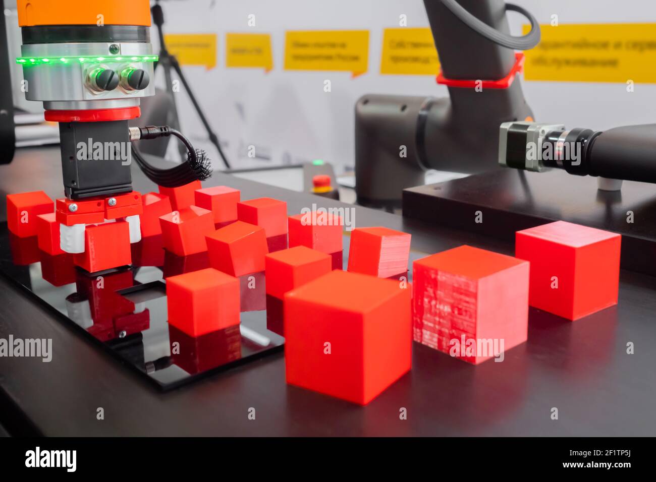 Pick and place robotic arm manipulator moving red toy blocks at robot exhibition Stock Photo - Alamy