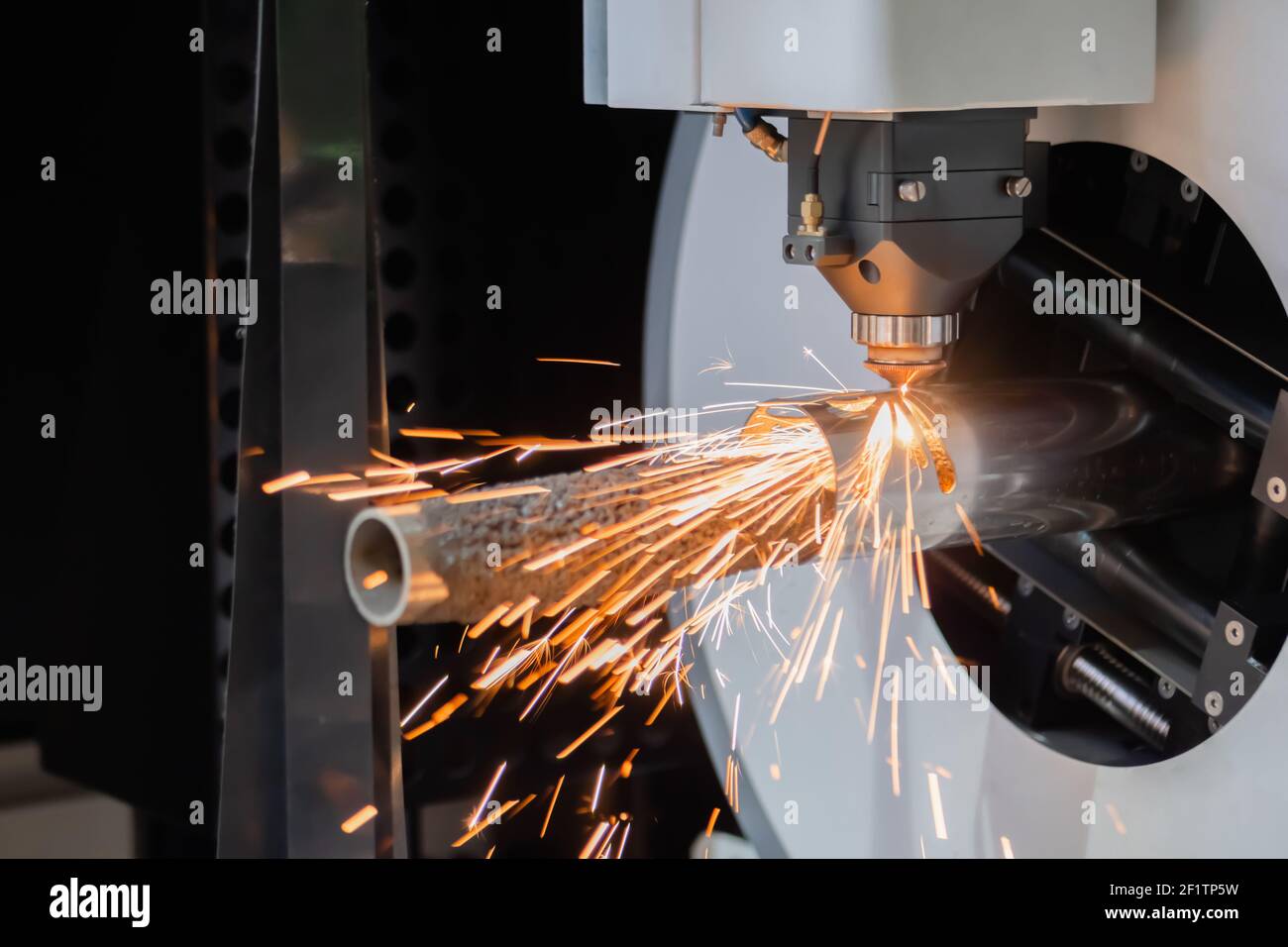 Laser cutting machine working with cylindrical metal workpiece with ...