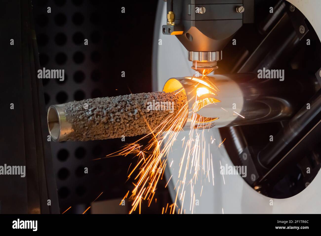 Cnc laser cutting machine working with cylindrical metal workpiece with ...