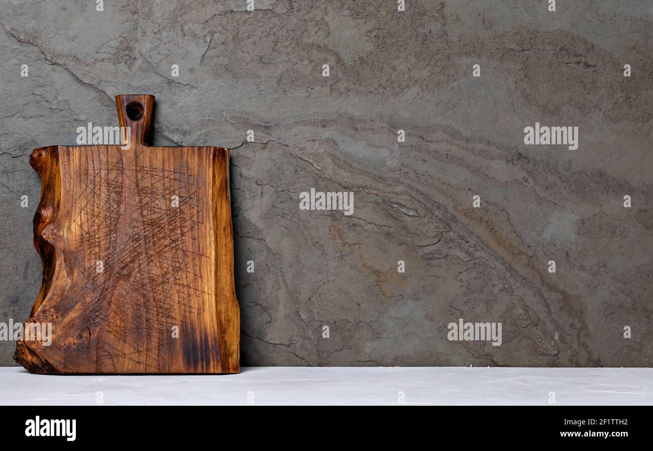 Cutting board on wooden kitchen table Stock Photo - Alamy