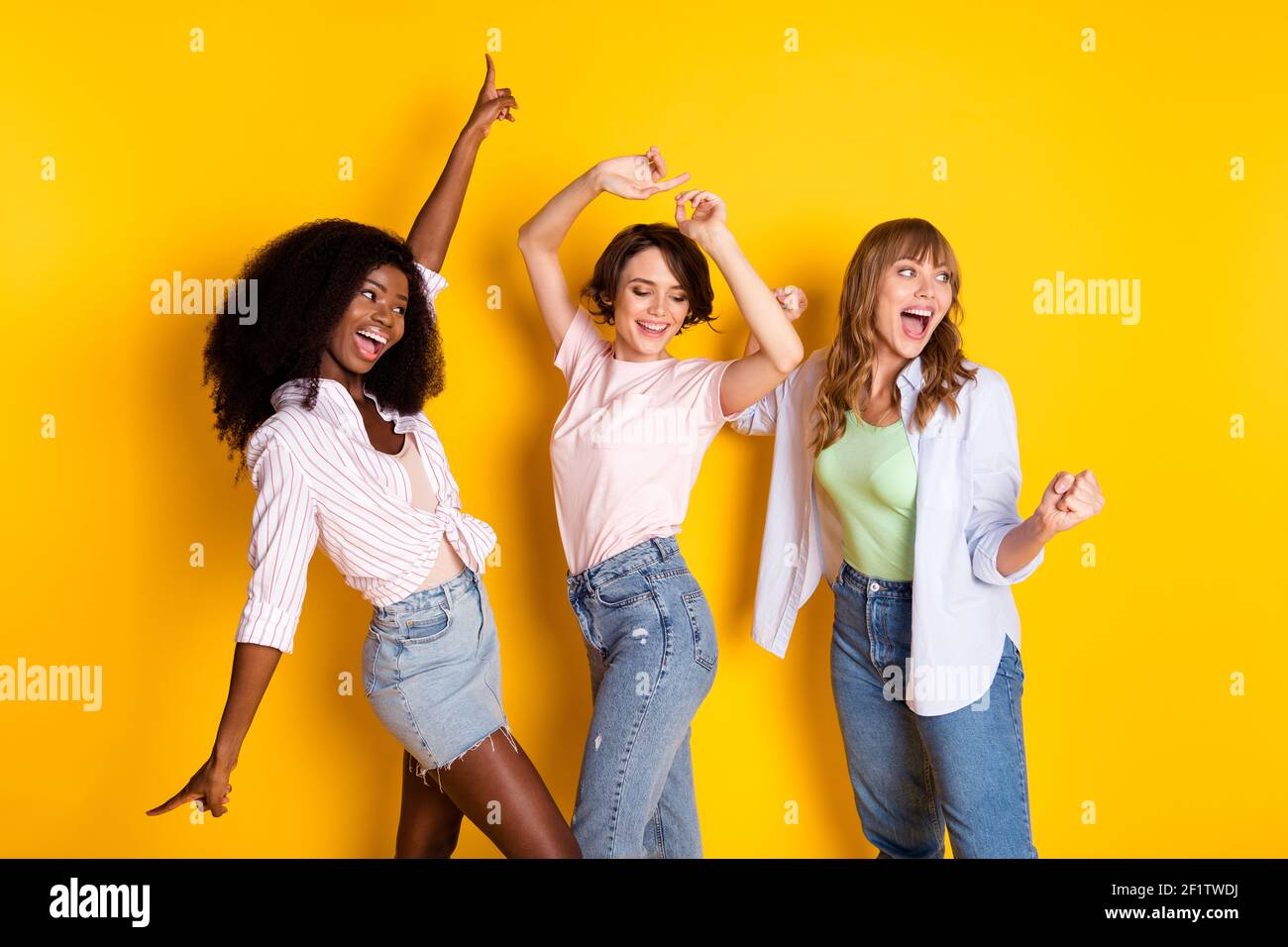 Portrait of three attractive cheerful girls dancing having fun ...