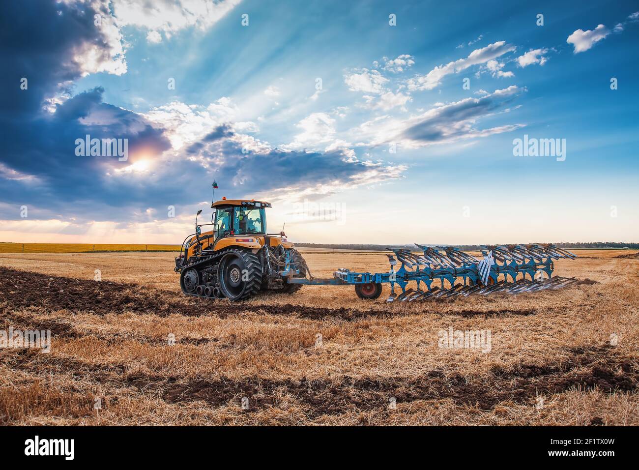 Tractor plowing the fields , agricultural landscape Stock Photo - Alamy